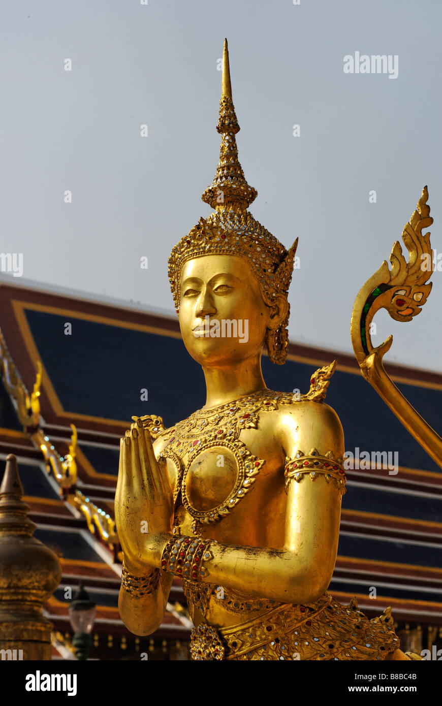 Golden Kinnara statue forming a Wai hand gesture - Wat Phra Kaew and ...