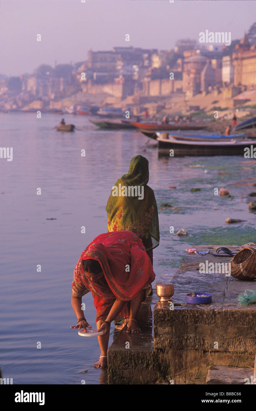 Women clean objects by river Varanasi (aka Benares), Uttar Pradesh ...