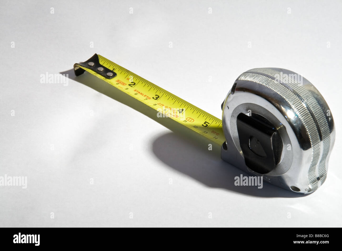 A silver tape measure against a white background Stock Photo - Alamy