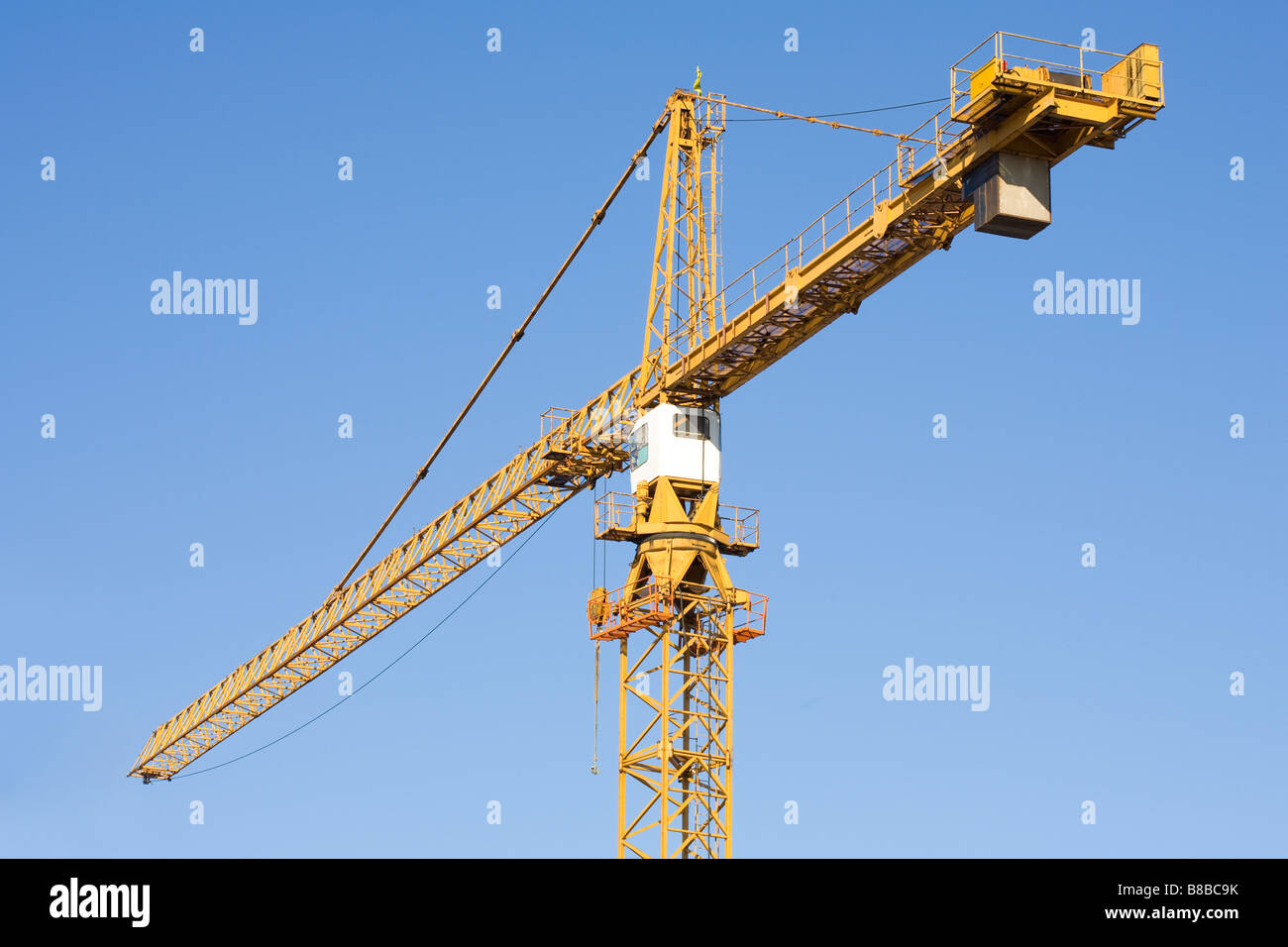 Big yellow crane on blue sky background Stock Photo - Alamy