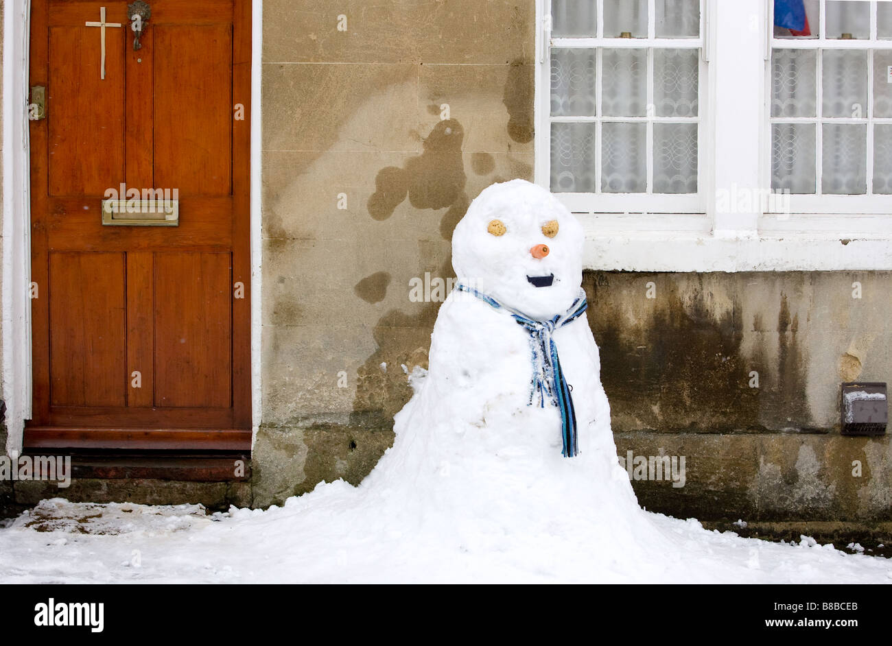 Snowman outside a uk home after a winter storm Stock Photo - Alamy