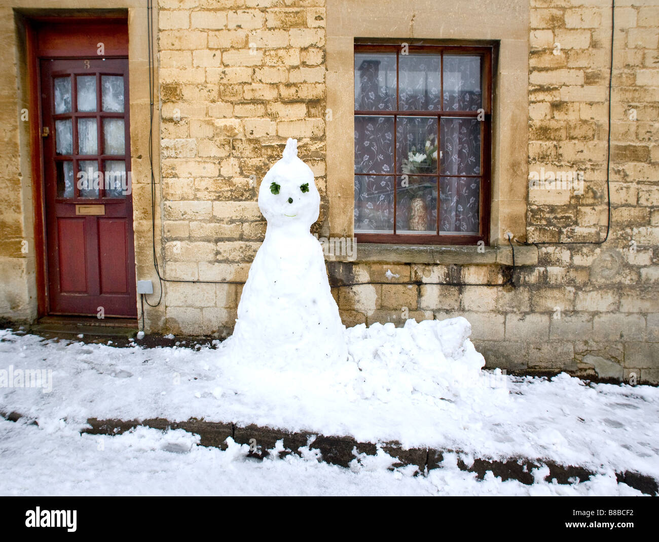 Snowman outside a uk home after a winter storm Stock Photo - Alamy
