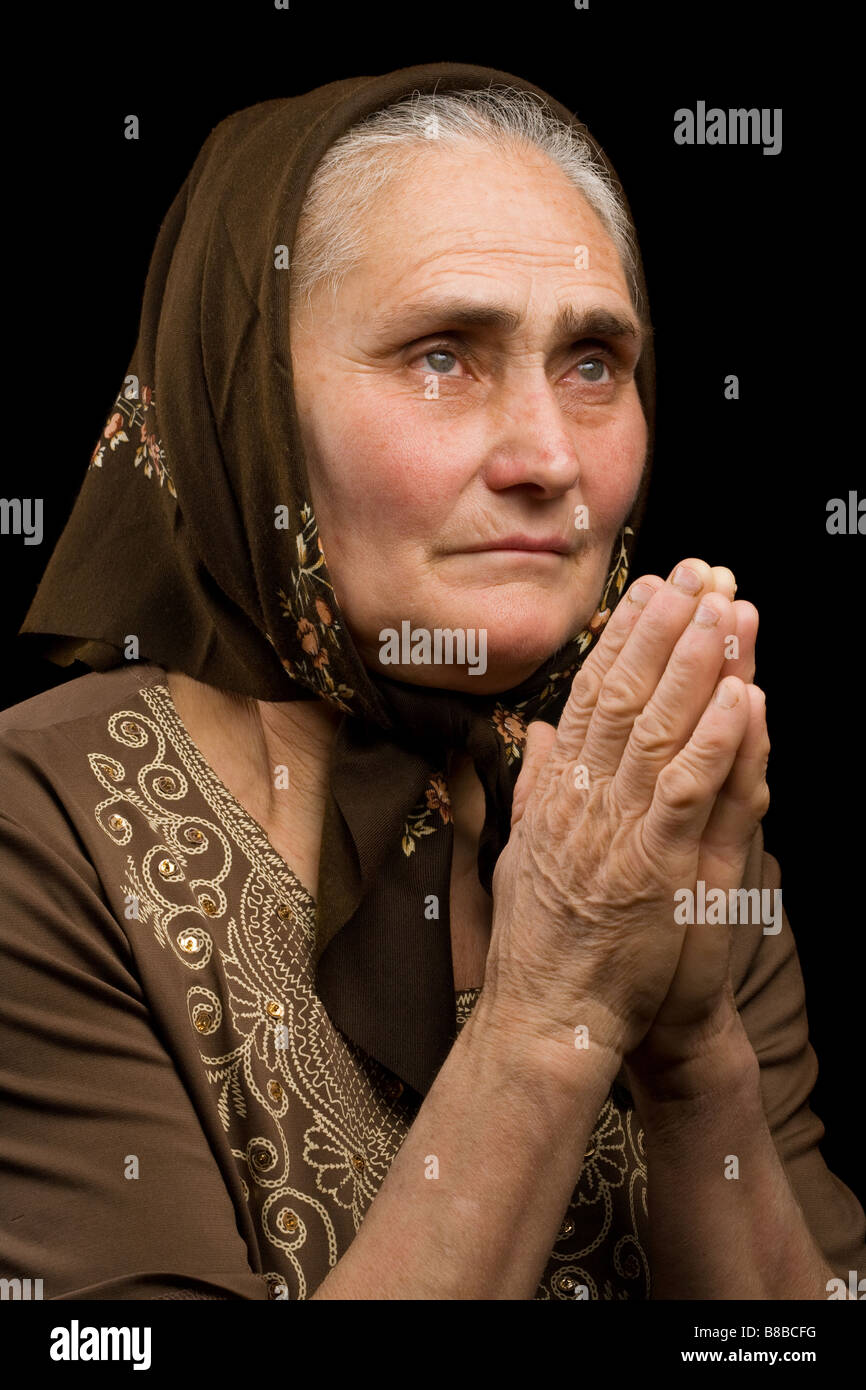 Close up portrait of an old woman praying Stock Photo - Alamy