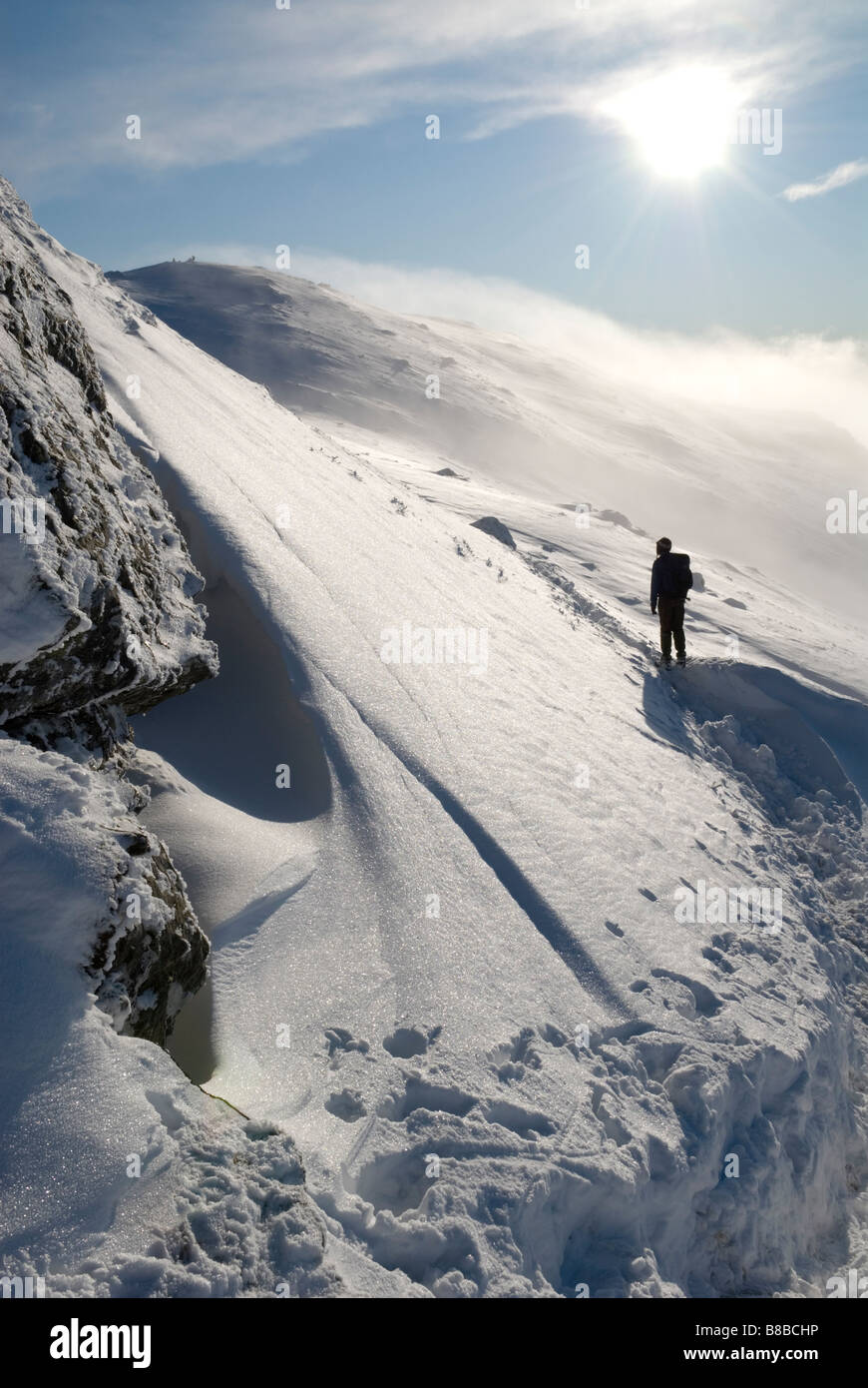 Female hill walker ascending the munro of An Caisteal in winter ...