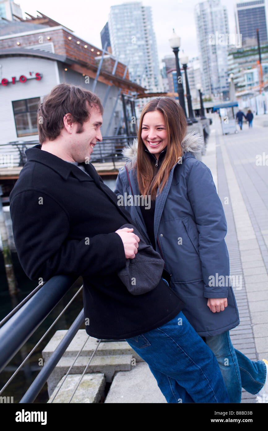 Zoom Photographics; Couple leaning against railing Stock Photo - Alamy