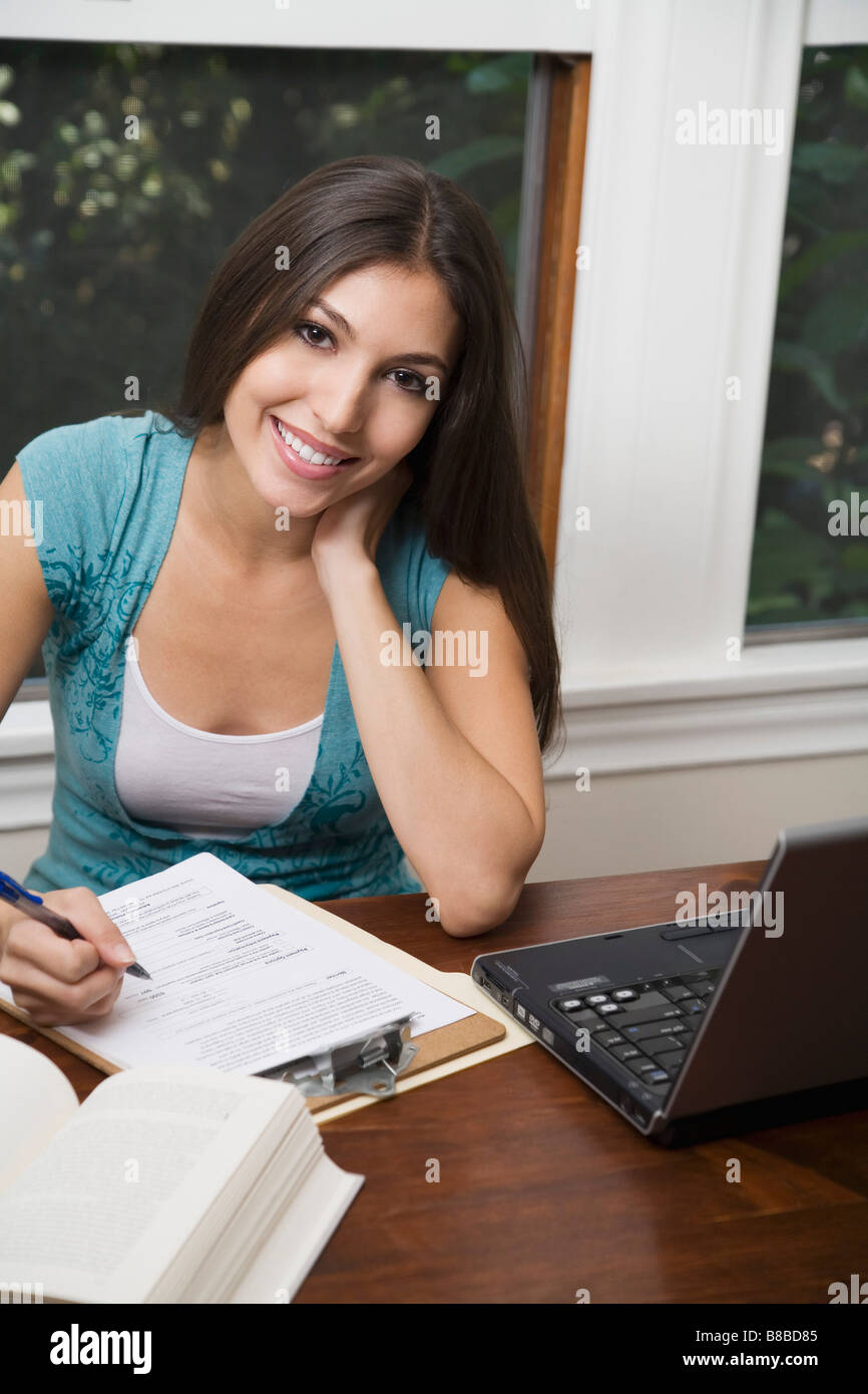 Portrait Woman doing Paper Work Sitting Table Laptop Stock Photo - Alamy