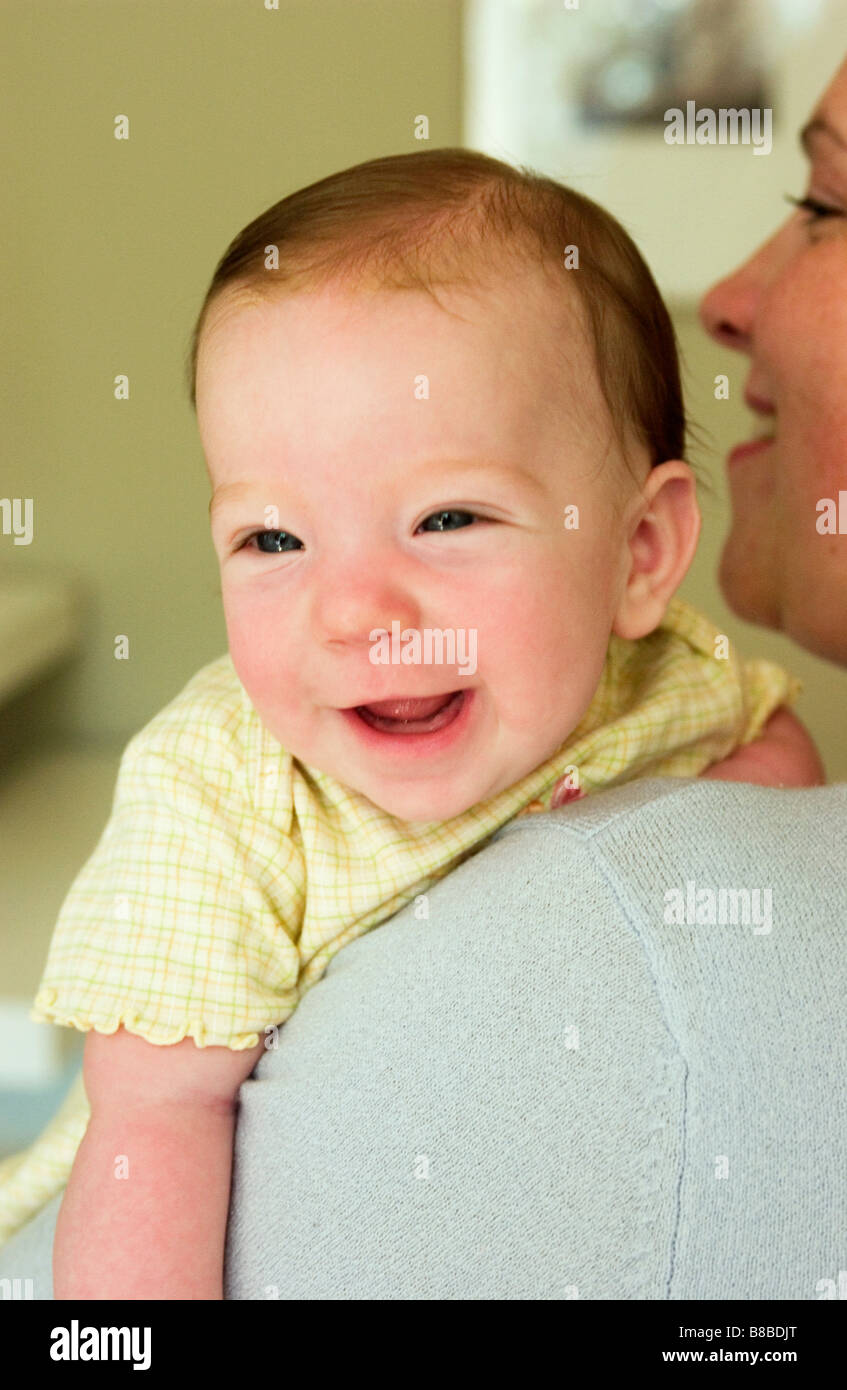 Infant Laughing Mothers arms Stock Photo - Alamy