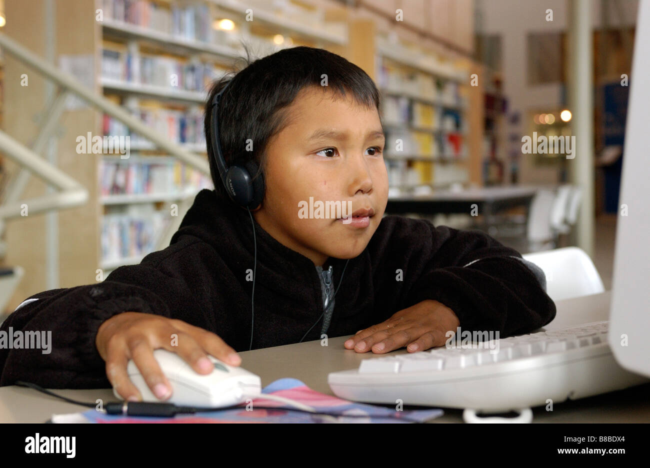 Boy working computer, Library,Cambridge Bay, Nunavut Stock Photo - Alamy