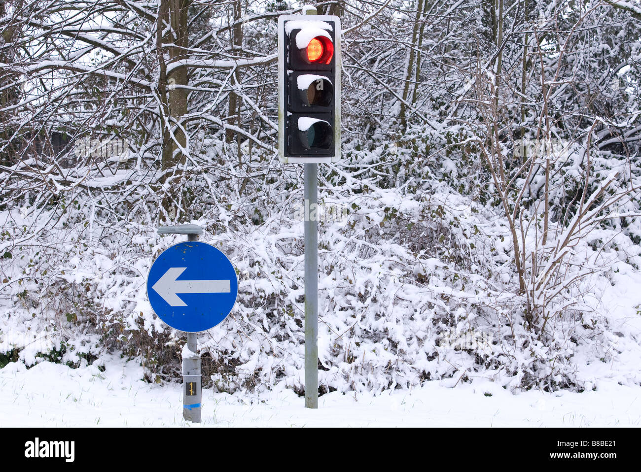 Road sign and traffic lights photographed after a winter snow storm in ...