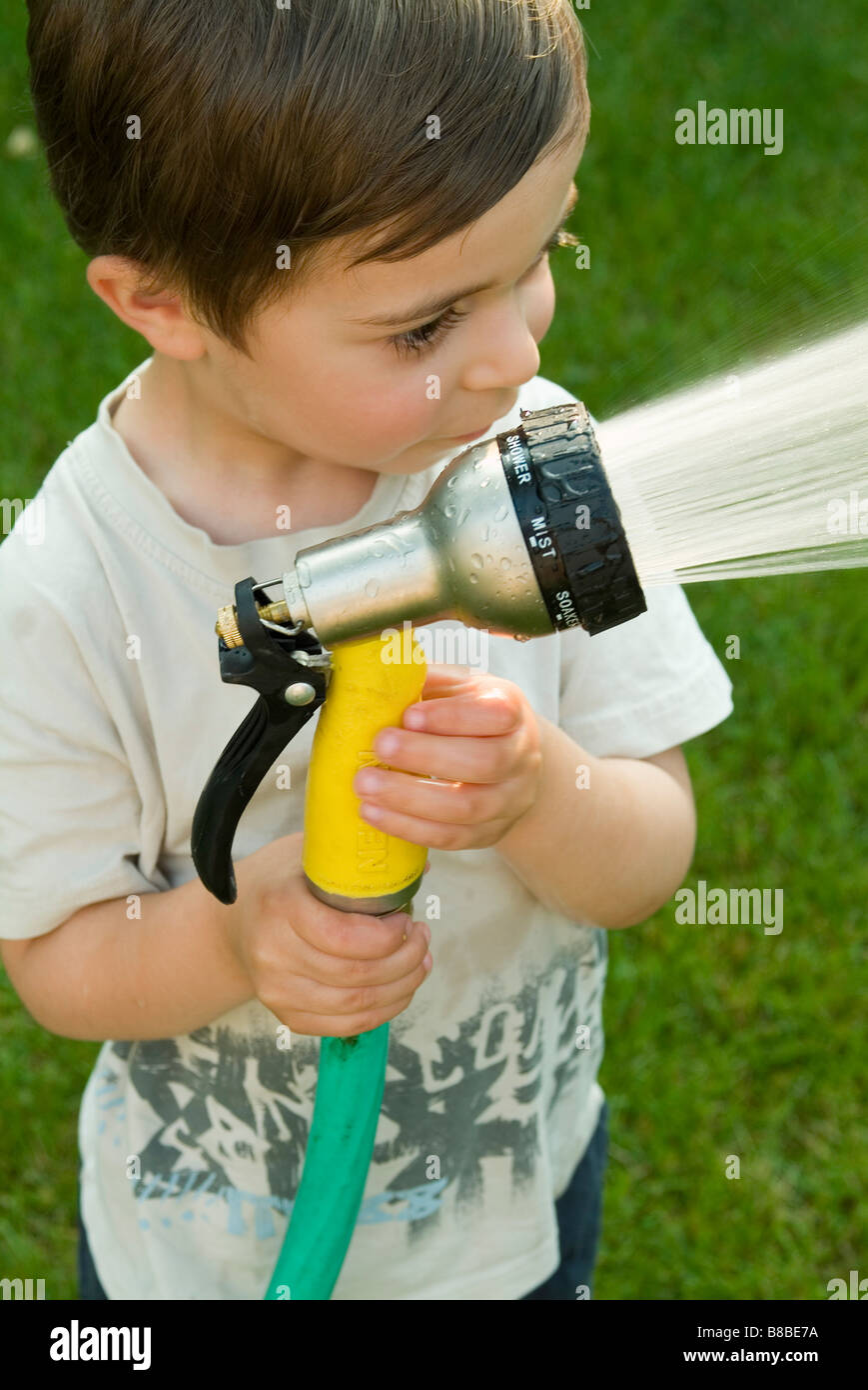 Little Boy Spraying Water Hose Stock Photo - Alamy