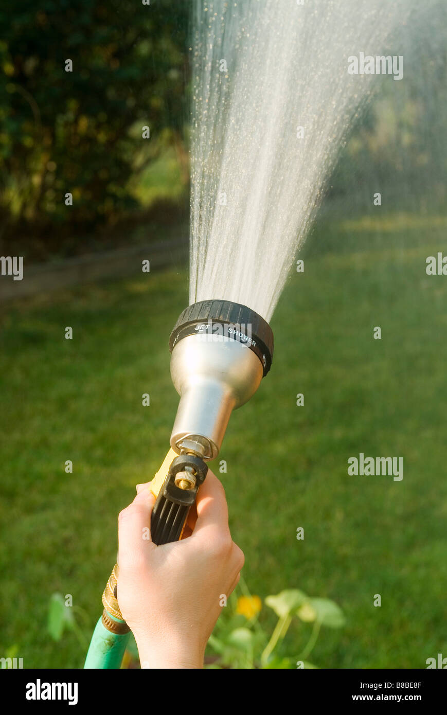 Hand Holding Hose Spraying Water Stock Photo - Alamy
