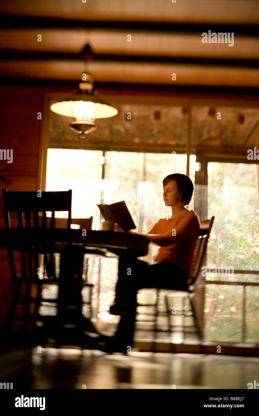 Woman reading a book and relaxing inside a cabin Stock Photo - Alamy
