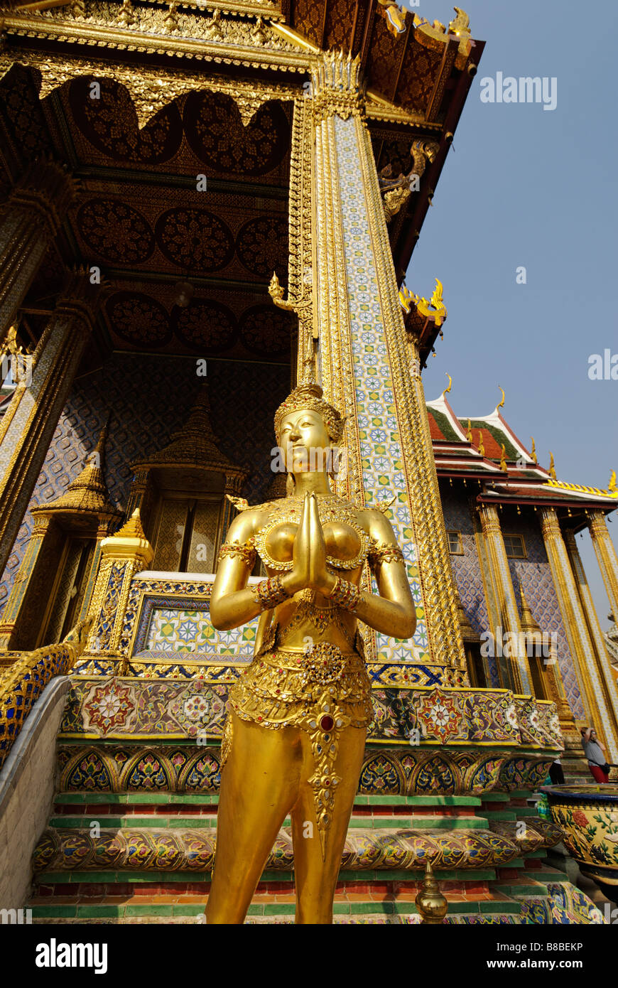Golden Kinnara statue forming a Wai hand gesture - Wat Phra Kaew and ...