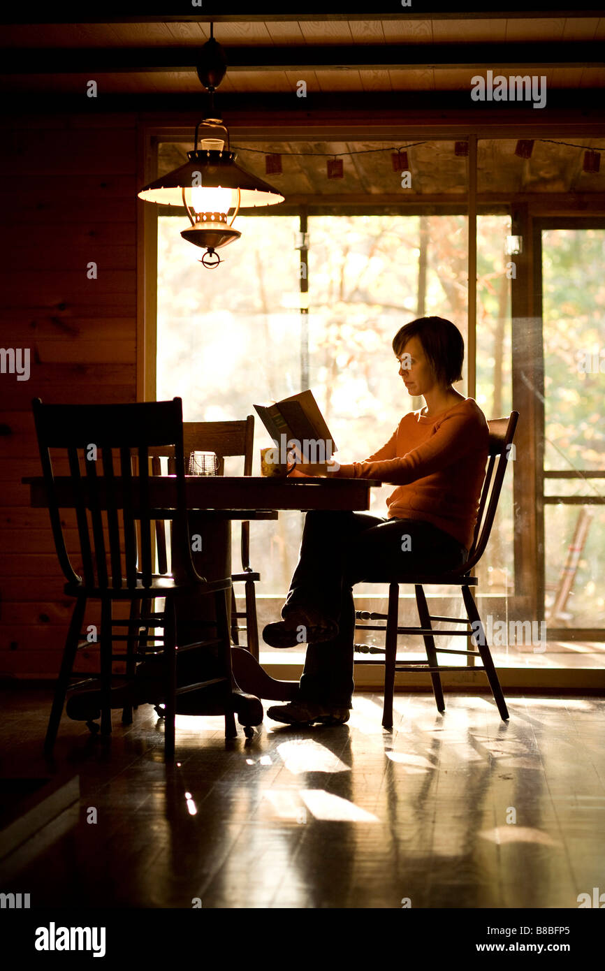 Woman reading a book and relaxing inside a cabin Stock Photo - Alamy