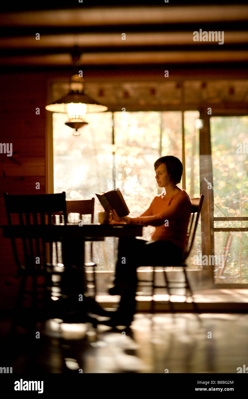 Woman reading a book and relaxing inside a cabin Stock Photo - Alamy