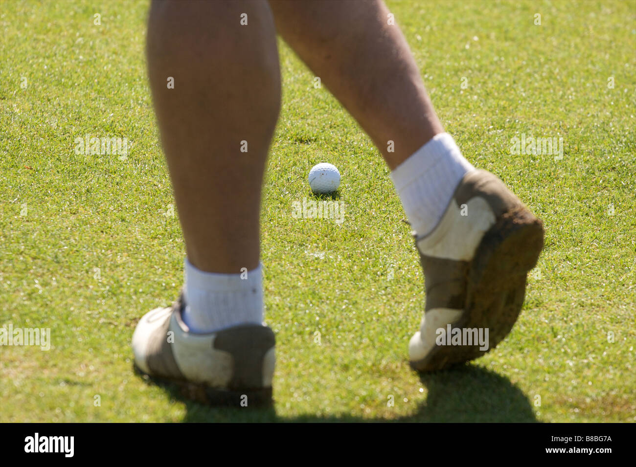 man swinging at golf ball Stock Photo - Alamy
