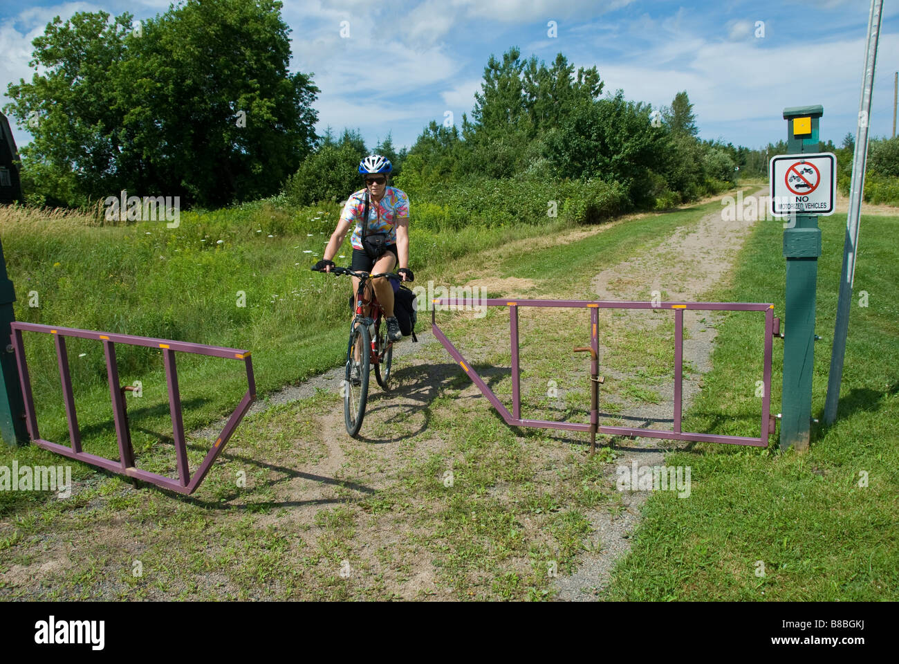 Woman rides through the trail gates at Ellerslie, Confederation Trail ...