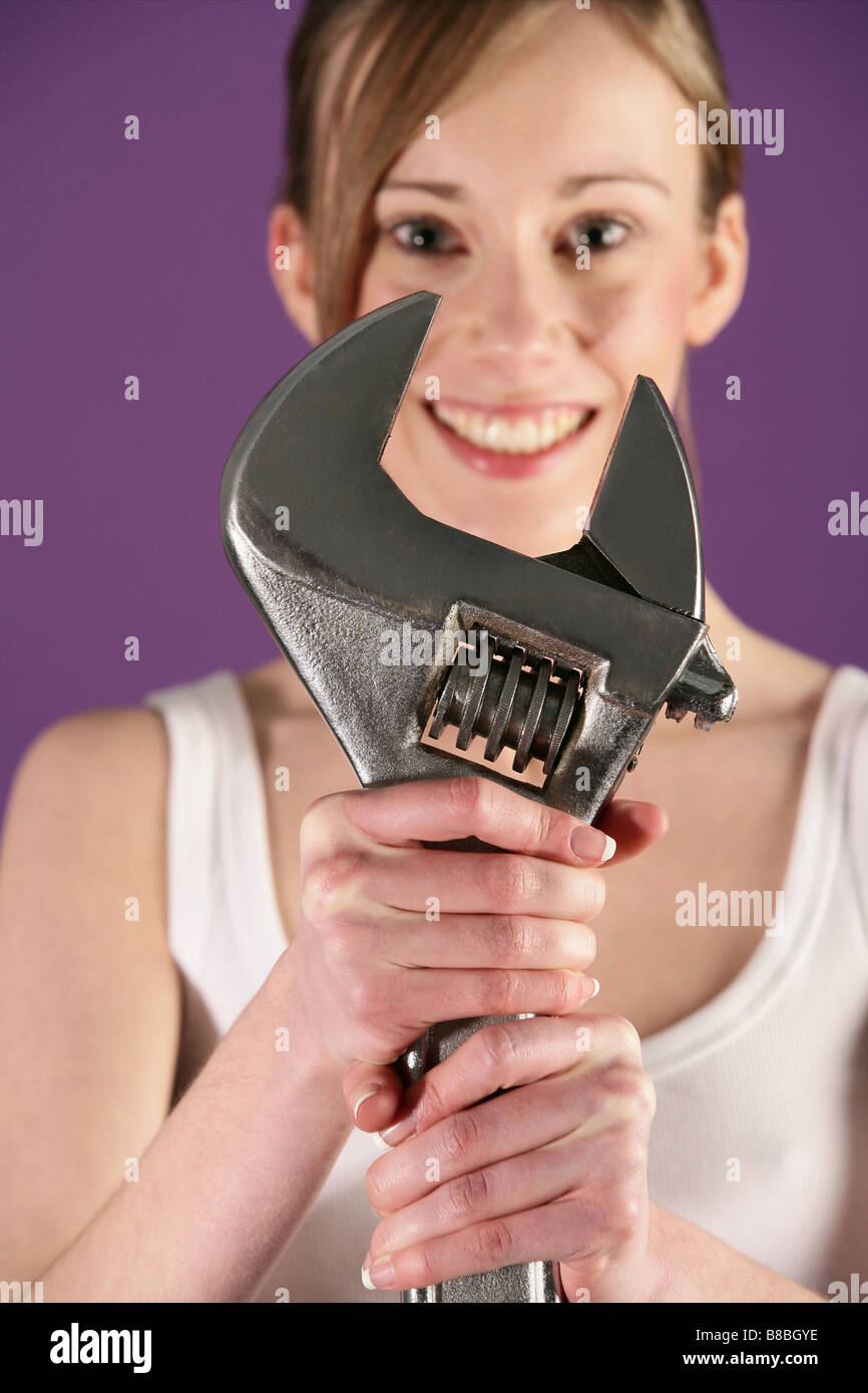 girl holding a huge adjustable spanner Stock Photo - Alamy