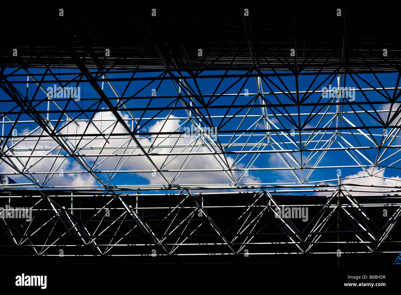 top of a factory opened and showing blue sky with clouds and structure ...