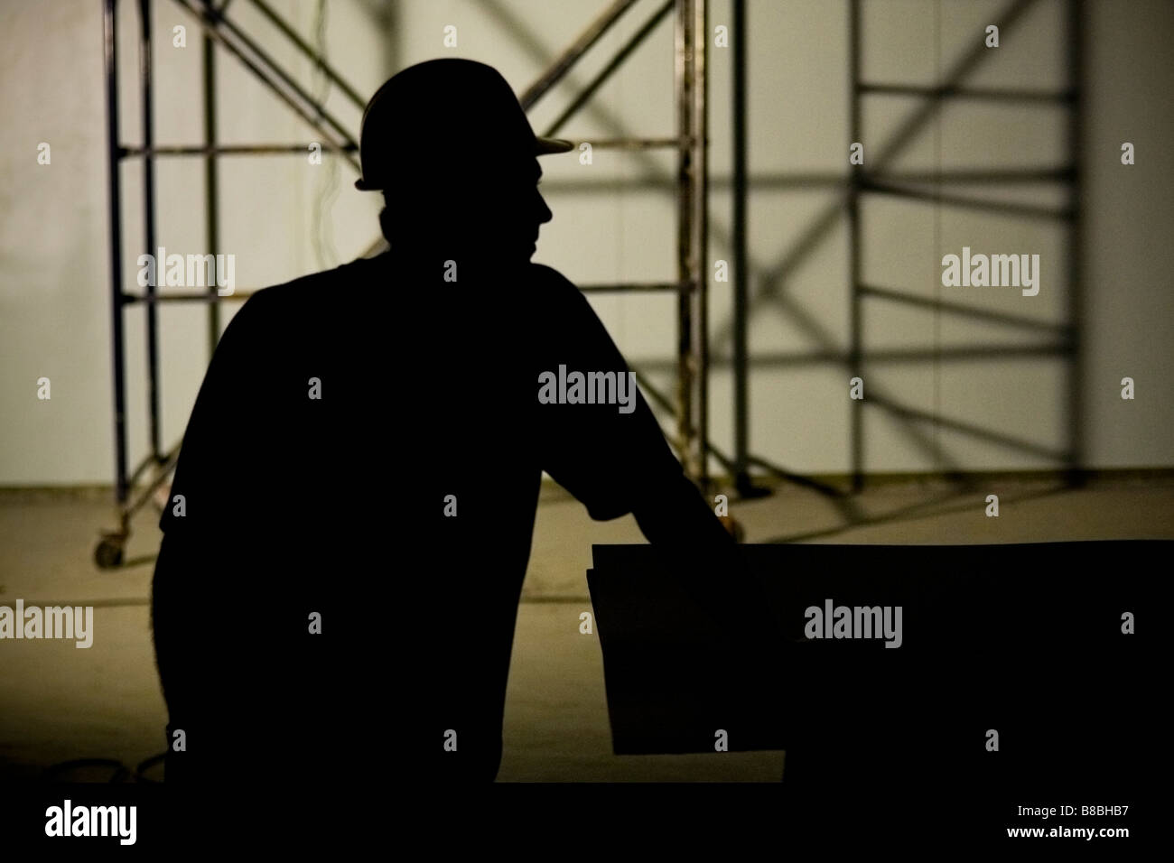 silhouette of a man inside a factory being built Stock Photo - Alamy