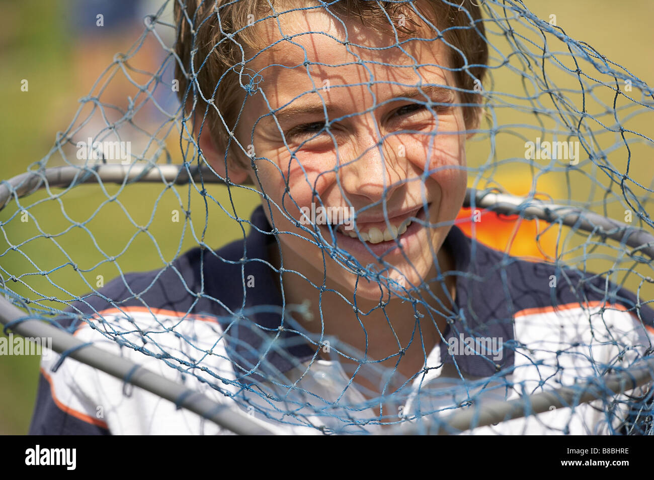 Boy Smiling Fishing net over his Head Stock Photo - Alamy