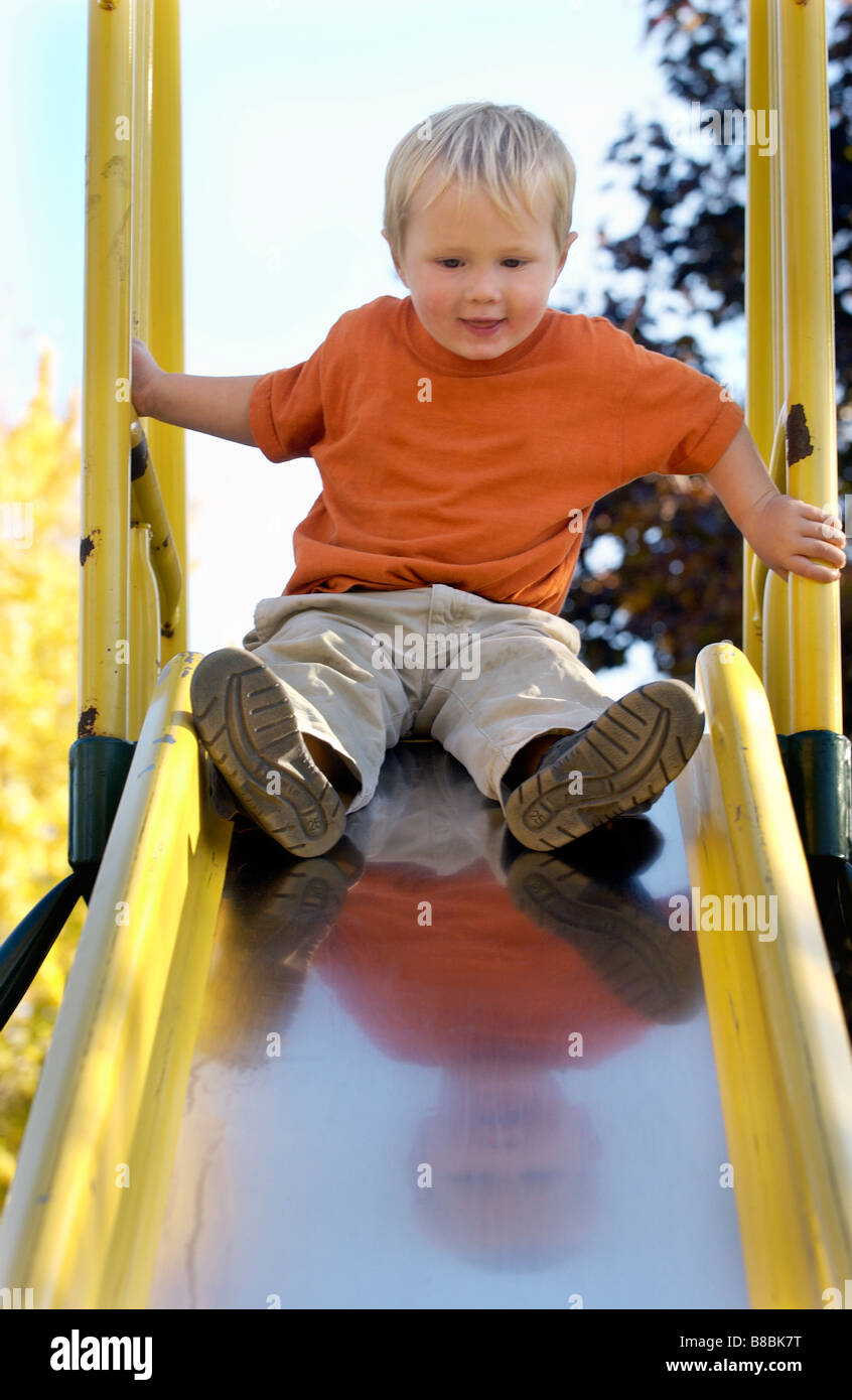 Boy Slide Playground Stock Photo - Alamy