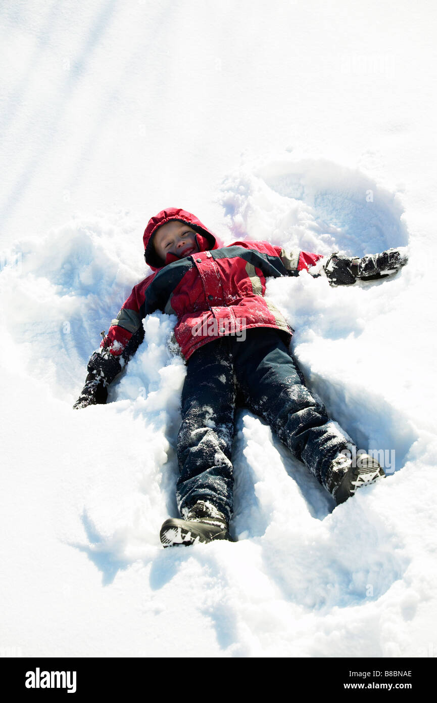 Boy Making Snow Angles Stock Photo - Alamy