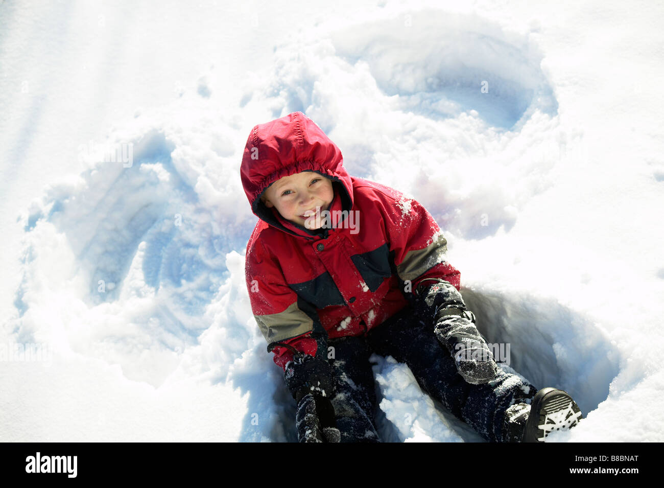 Boy Making Snow Angels Stock Photo - Alamy
