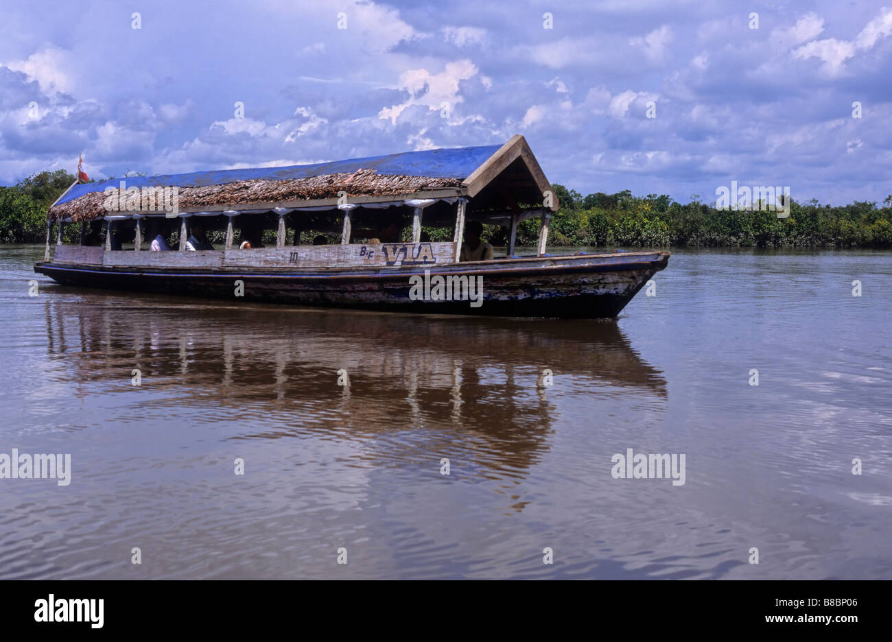 Small wooden ferry transporting passengers across part of the amazon ...