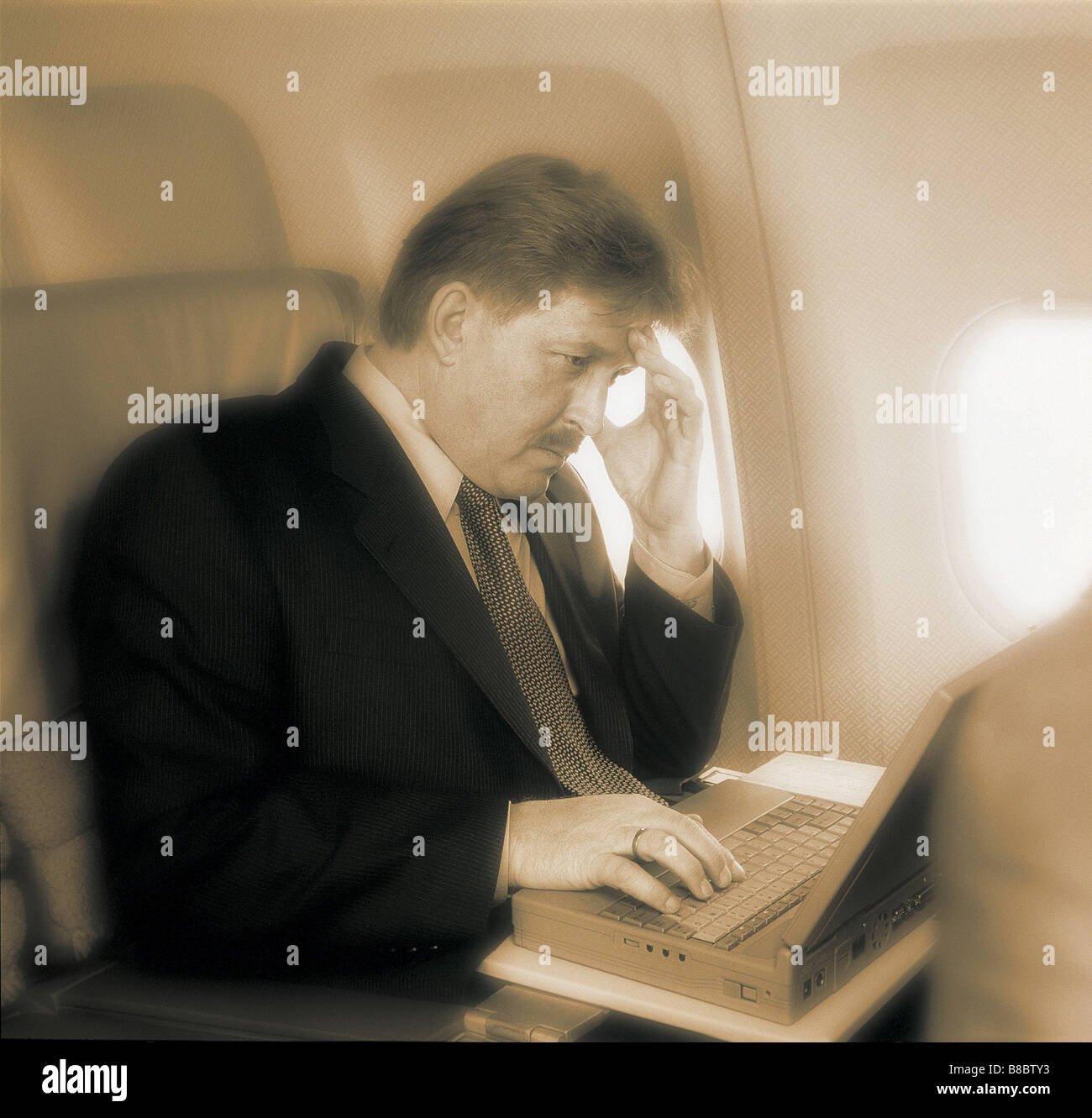 FL4778, Steve Lawrence; Stressed Out Businessman Airplane Laptop, Sepia ...