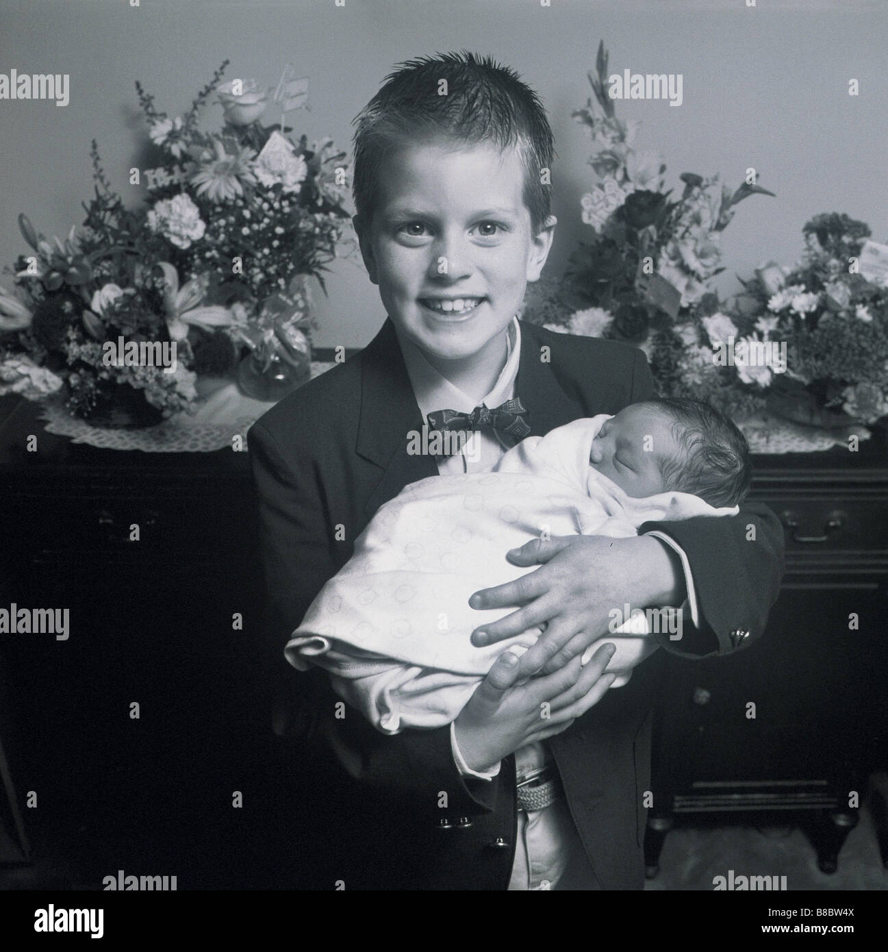 FL4833, Nick Kelsh; Boy Suit Holding New Baby, BW Stock Photo - Alamy
