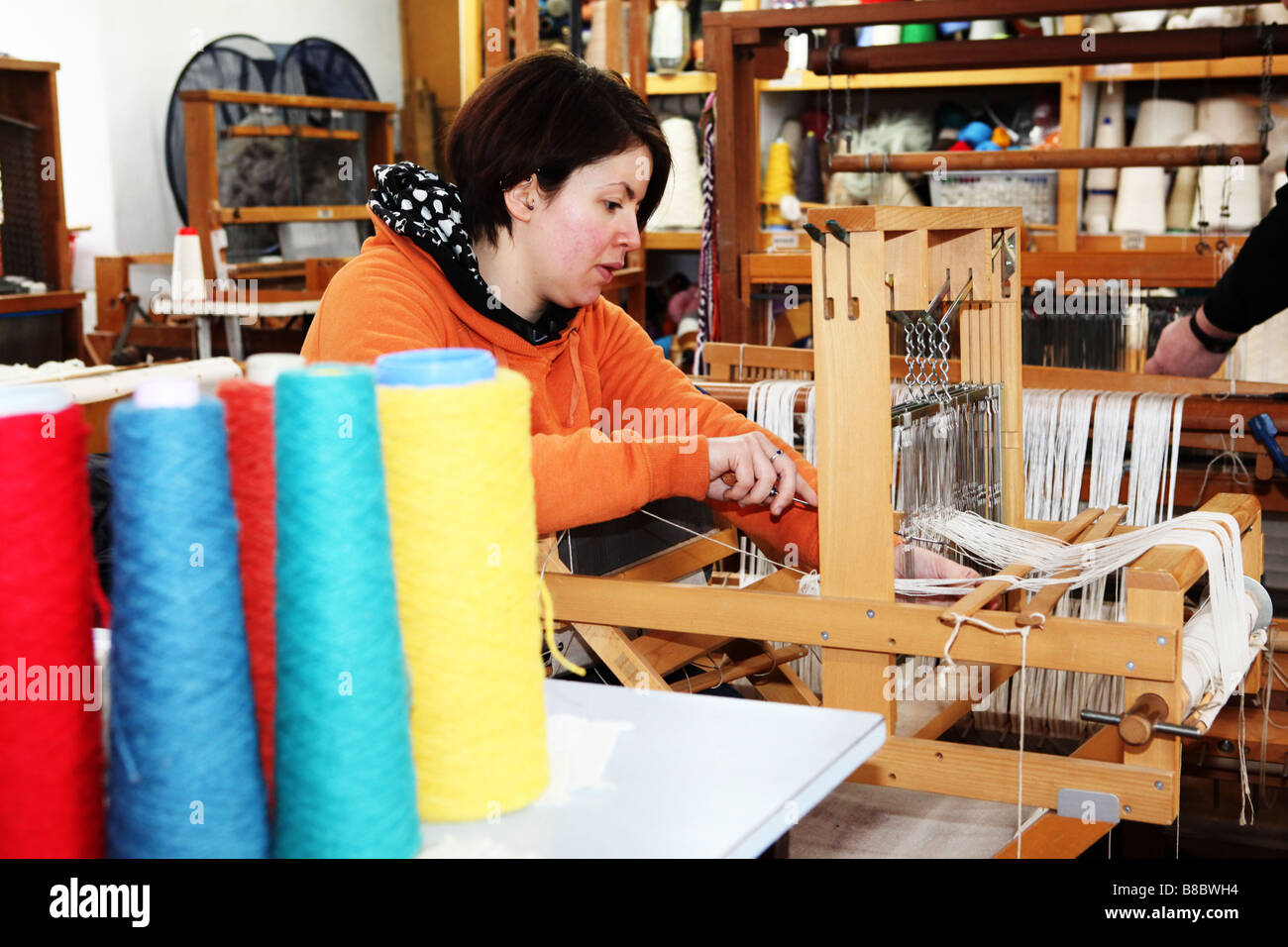 Textiles student learning traditional hand weaving skills in a small ...