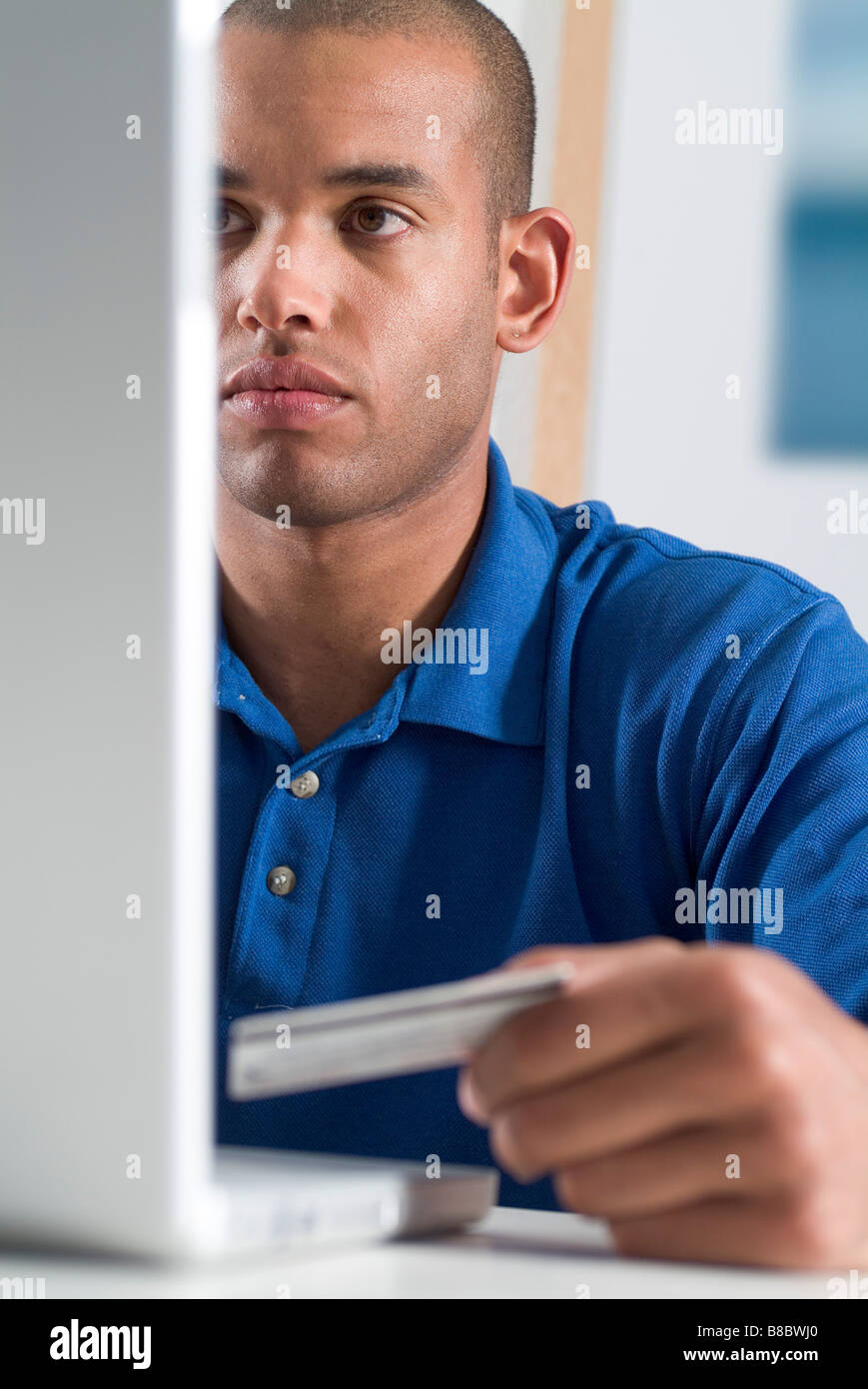 Young Man Making Credit Card Purchase Computer Stock Photo - Alamy