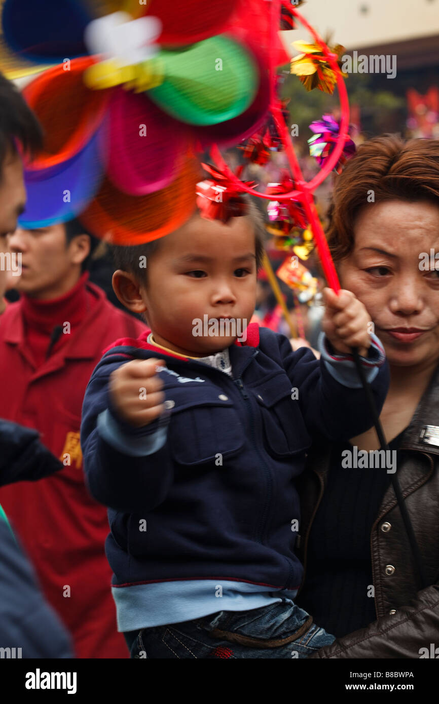Chinese mother and child with pinwheel at Che Kung temple in Hong Kong ...