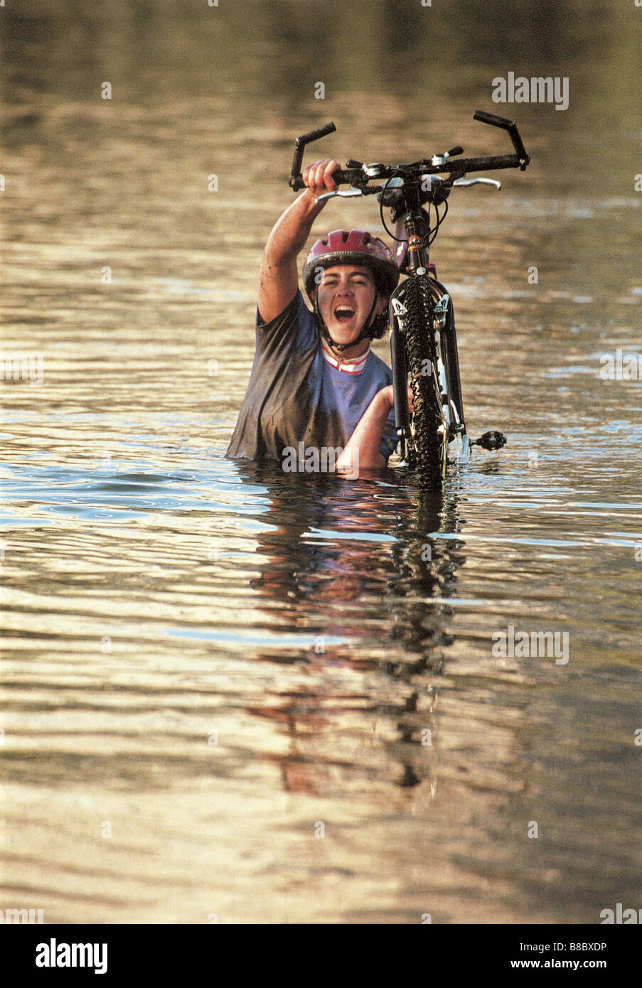 FL4976, Darwin Wiggett; Woman Carrying Mountain Bike Through Water ...