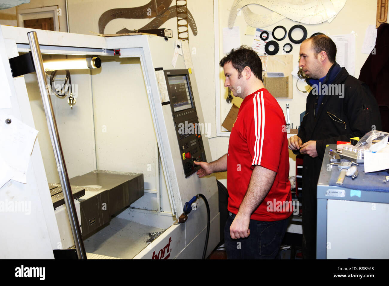 Skilled workers machine operators using a precision metal working lathe ... Skilled workers machine operators using a precision metal working lathe ...