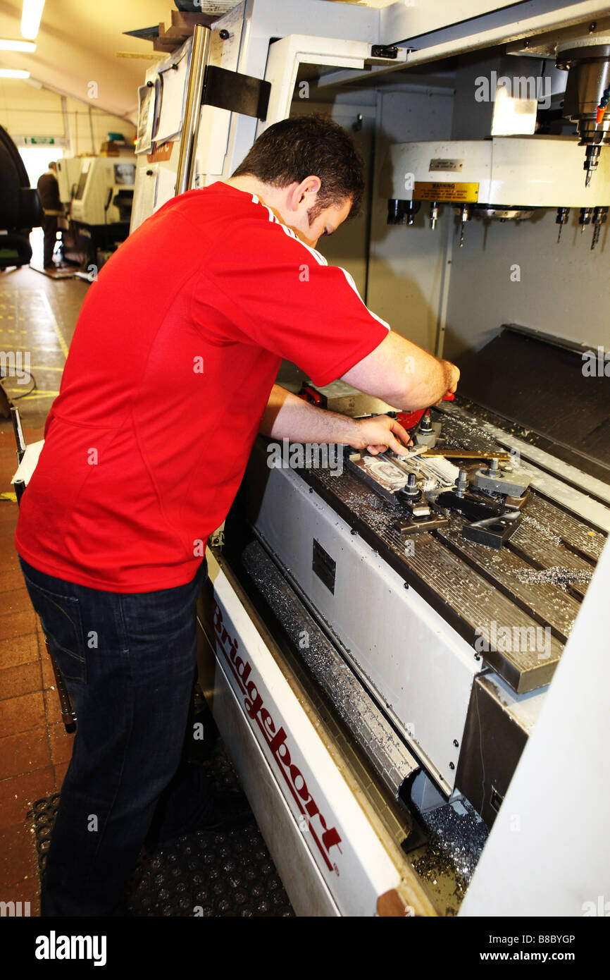 Skilled workers machine operators using a precision metal working lathe ...