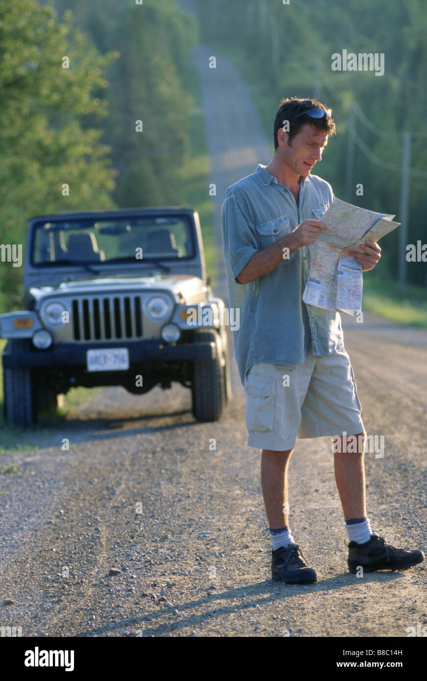 Man Standing Rural Road Jeep Looking Map Stock Photo - Alamy