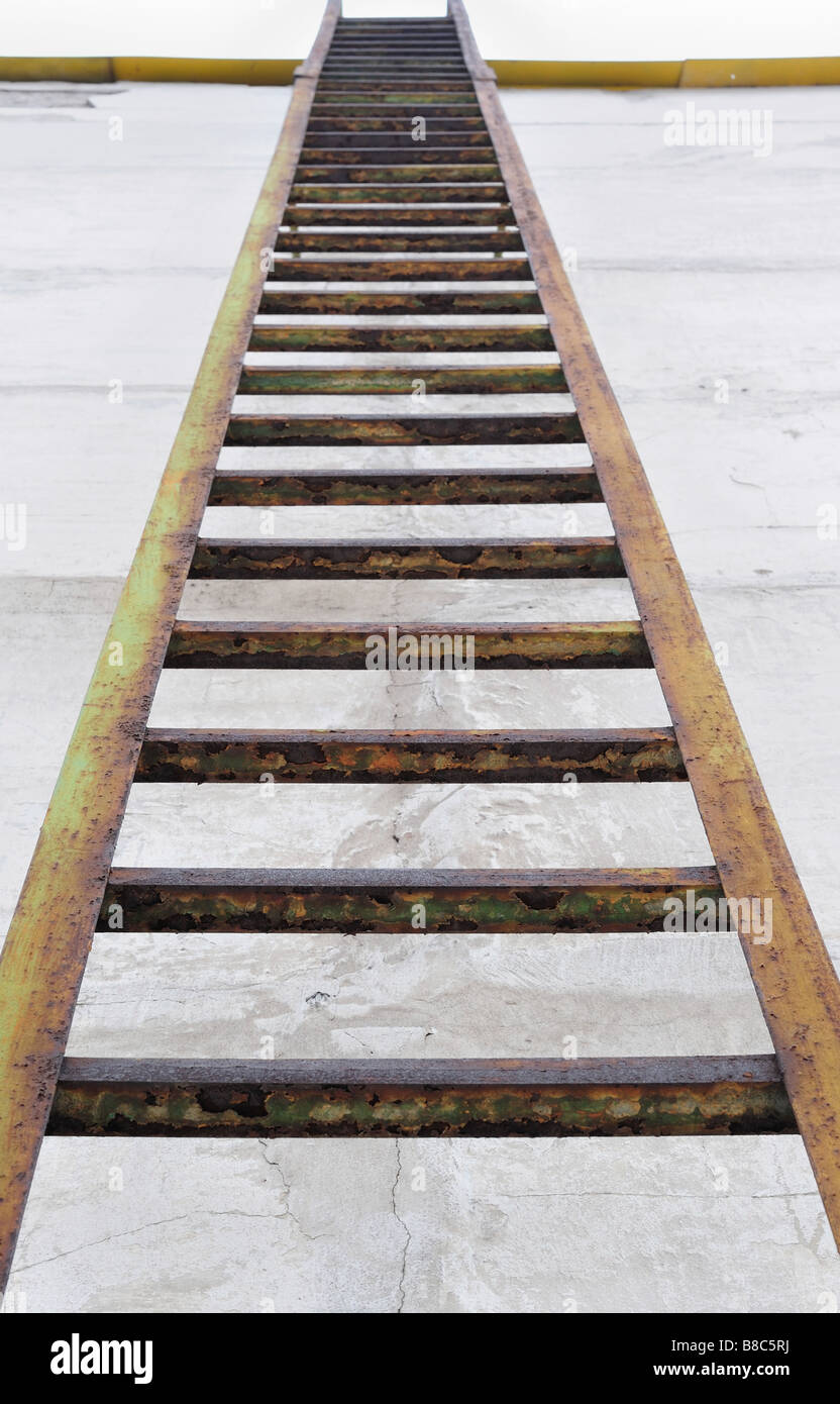 Ladder at a wall An old rusty ladder at a concrete wall Stock Photo - Alamy