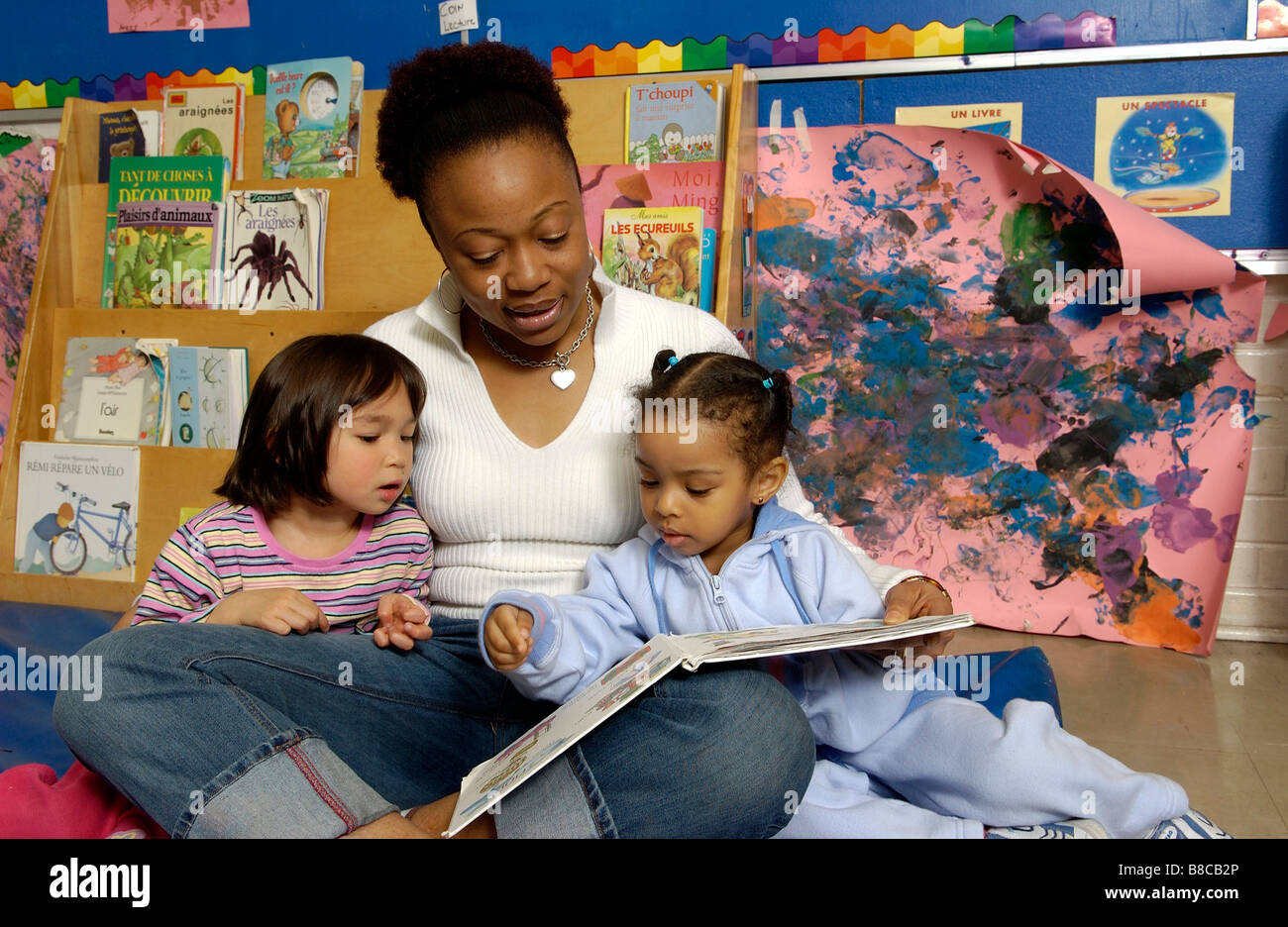 Daycare Worker Reading Four Year Old Girls Stock Photo Alamy daycare-worker-reading-four-year-old-girls-stock-photo-alamy