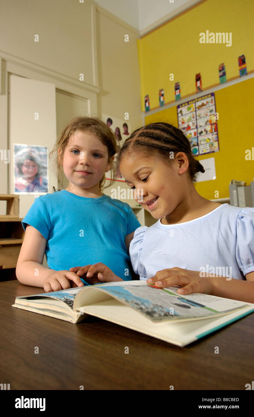 Young Girls Reading together Classroom Stock Photo - Alamy