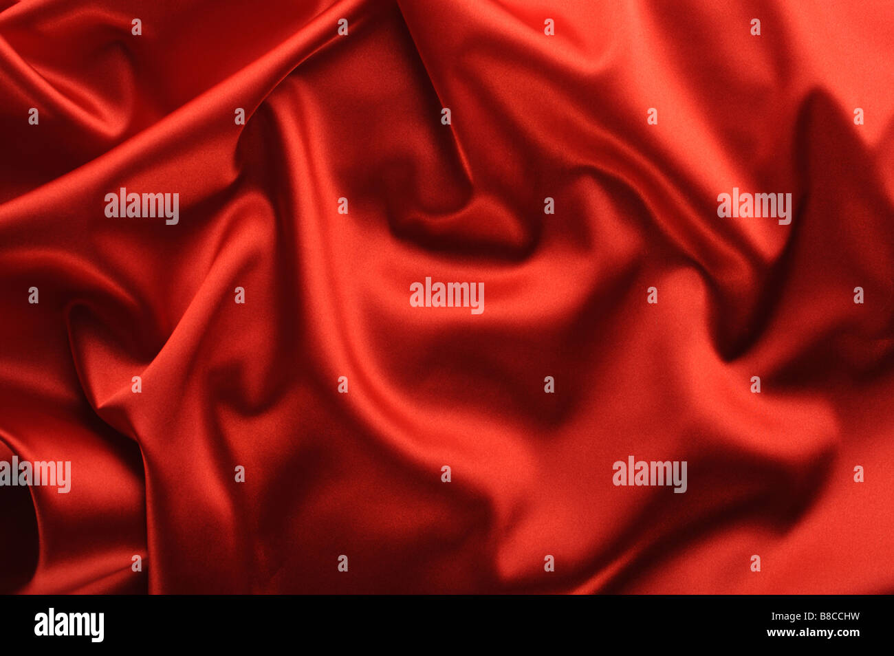 red satin background A satiny fabric with beautiful light shadow waves ...