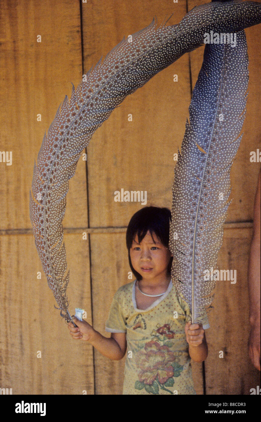 Girl showing off pheasant feather trophy Stock Photo - Alamy