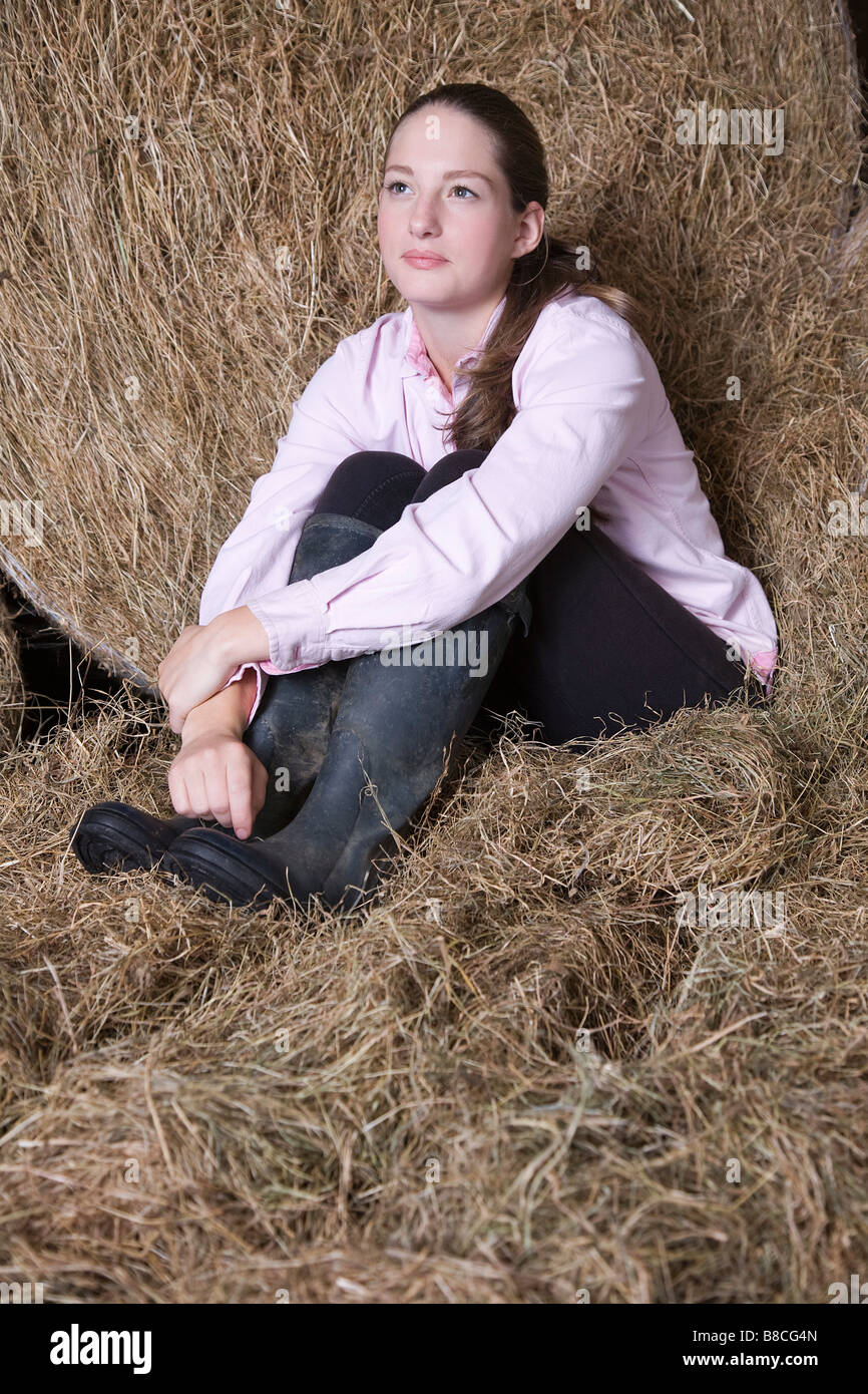 Girl relaxing in barn Stock Photo - Alamy