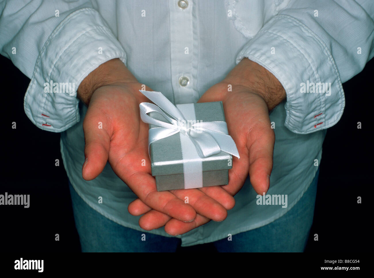 Man holding Present Stock Photo - Alamy