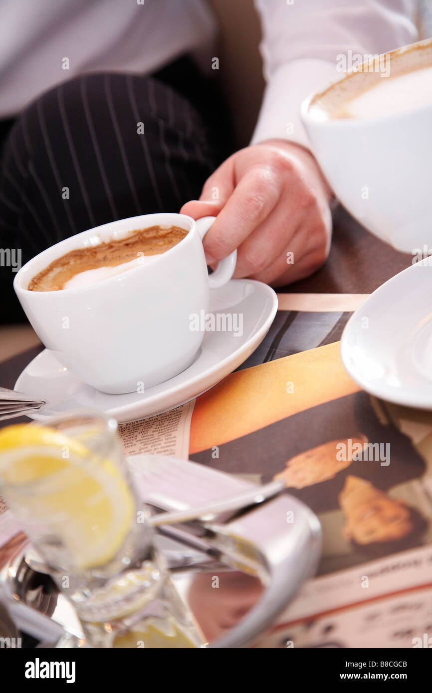 Two people sat drinking coffee Stock Photo - Alamy