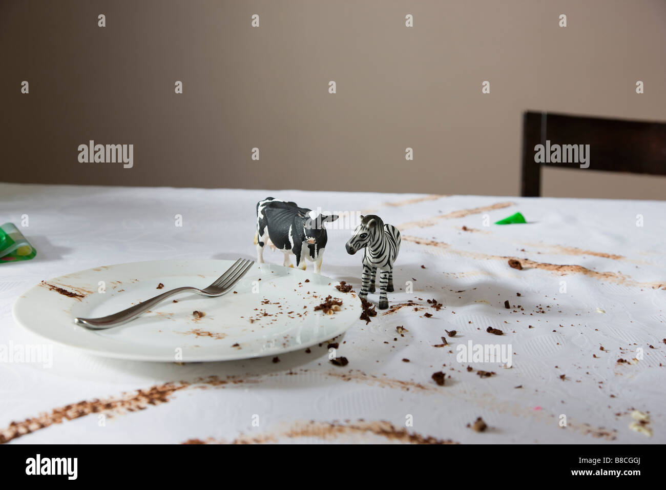 Animal figurines on messy table Stock Photo - Alamy