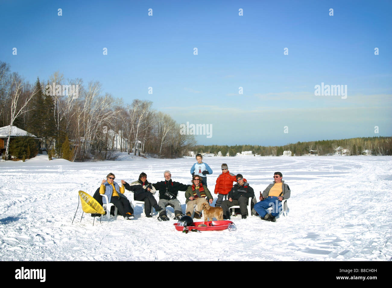 Group sitting Frozen Lake Stock Photo - Alamy