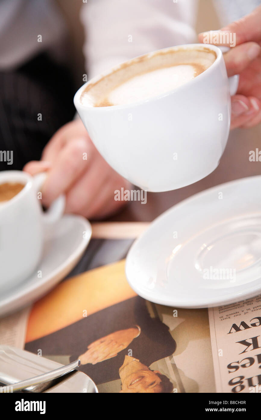 Two people sat drinking coffee Stock Photo - Alamy