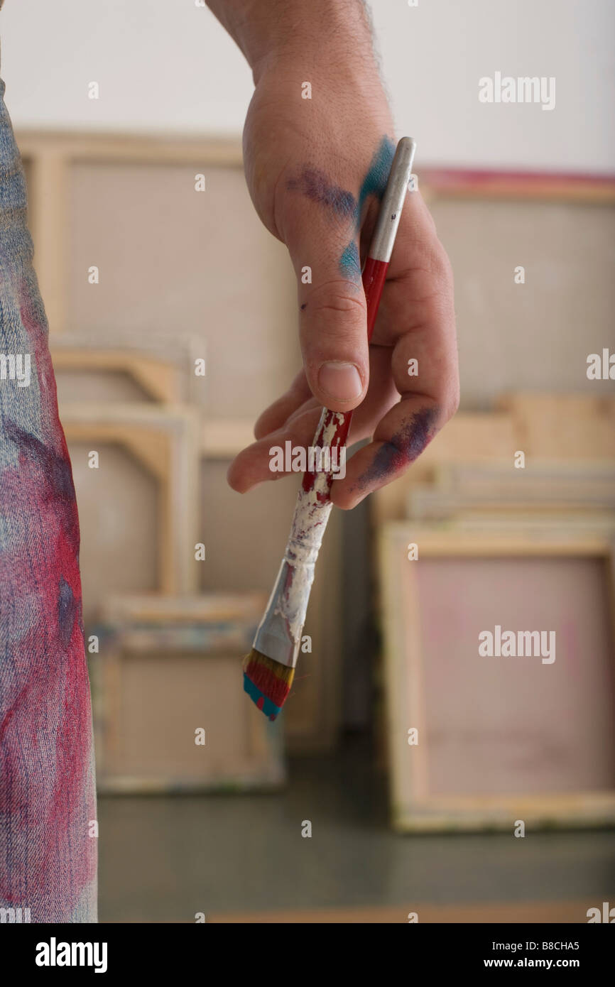 Paint on Artist's Hand and Paintbrush Stock Photo - Alamy